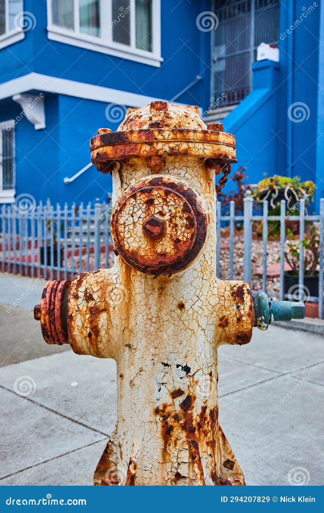 Rusted Fire Hydrant Vertical with Blue Home in Background of San ...