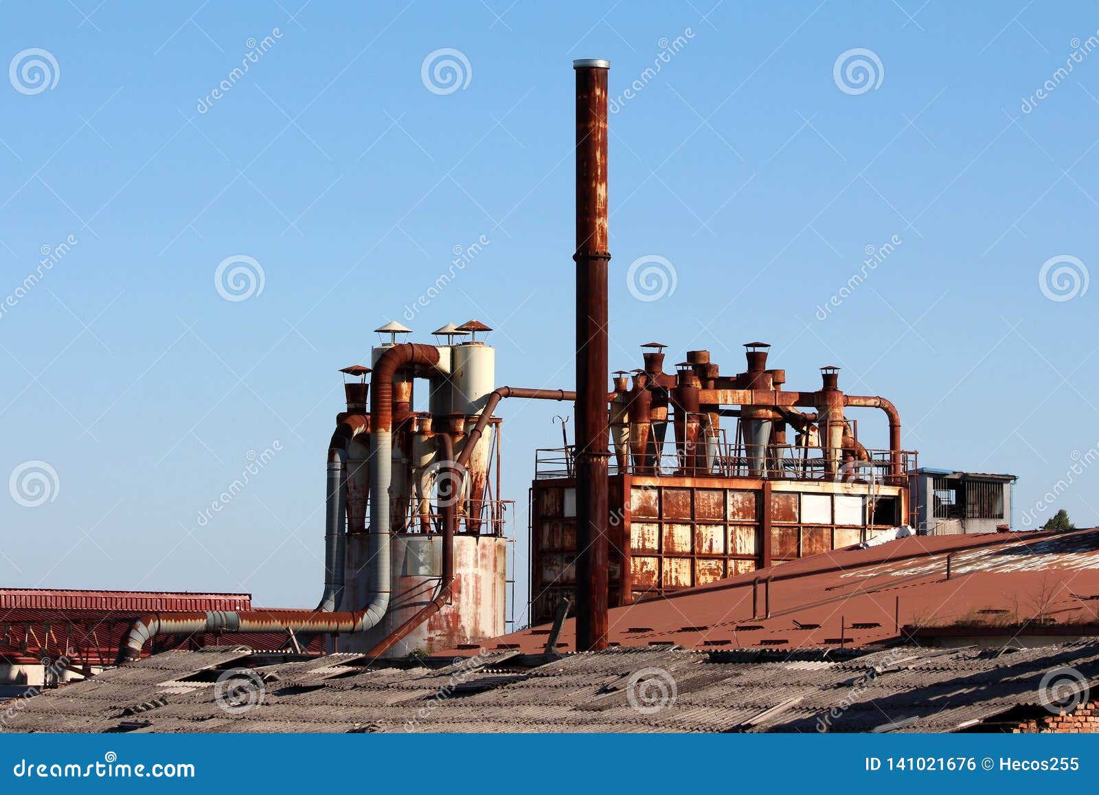 Rusted Metal Chimneys Surrounded with Large Storage Silos on Top of ...