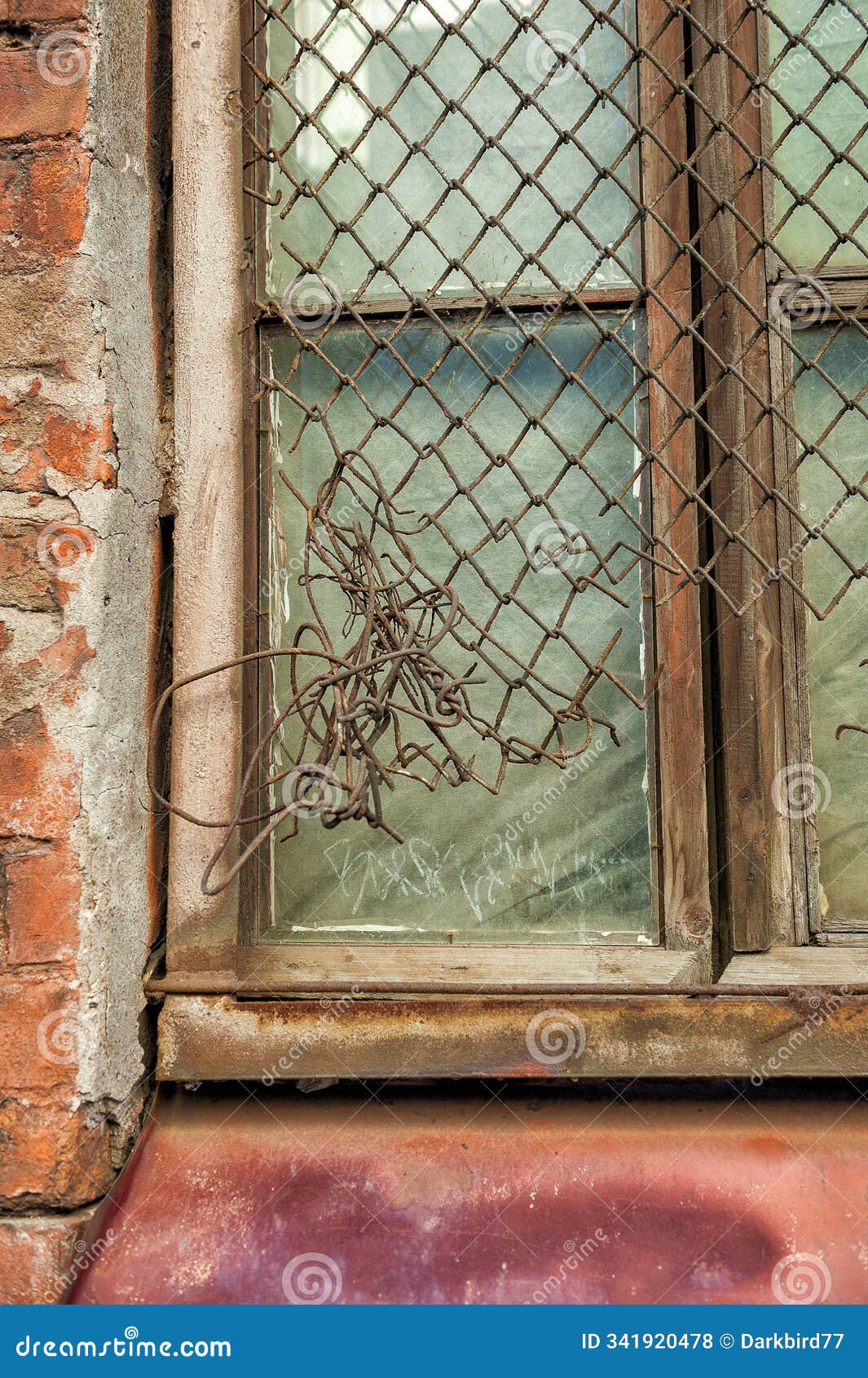 Rusted Metal Grid Guards A Weathered Glass Window In An Old Structure ...