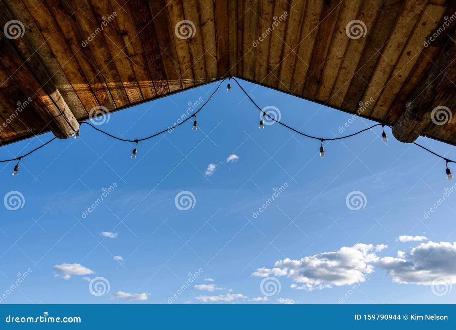 Rustic Background of Outdoor Wood Ceiling with Log Beams and String of ...