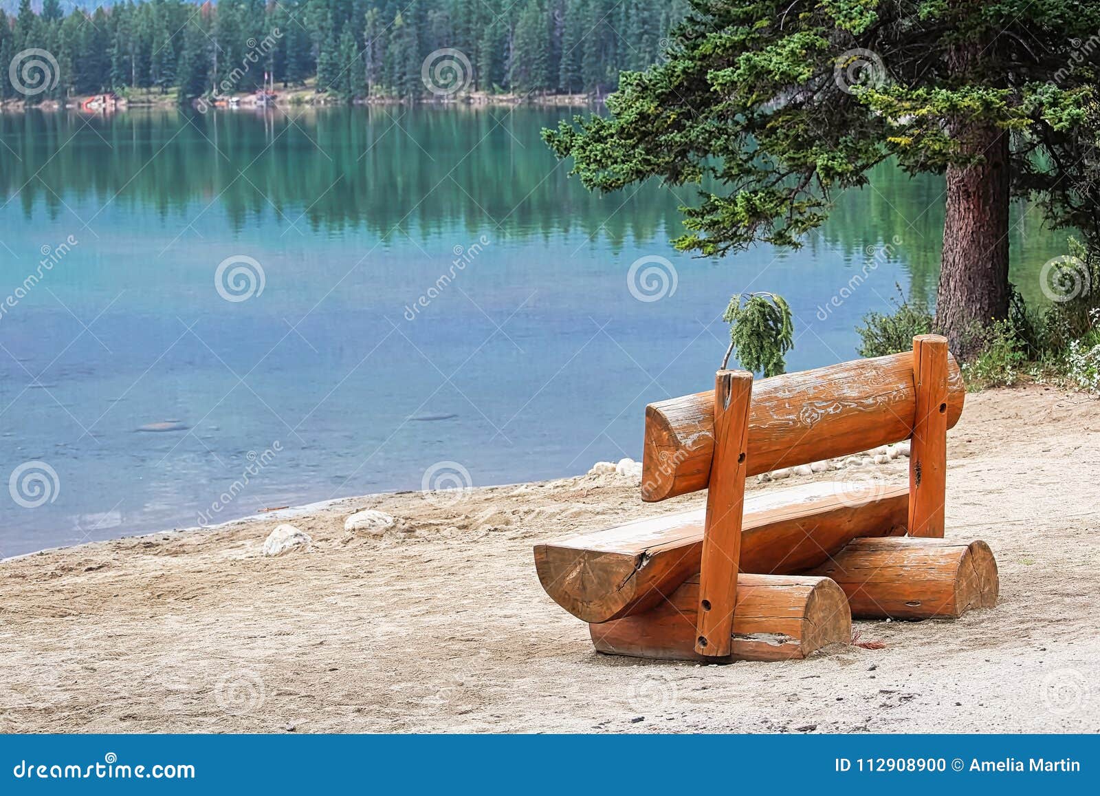 A Rustic Bench Sits on a Calm Lake Shore Stock Photo - Image of ...