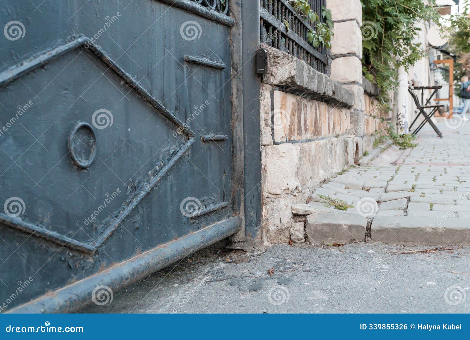 Rustic Blue Gate with Stone Pathway and Charming Street View Stock ...