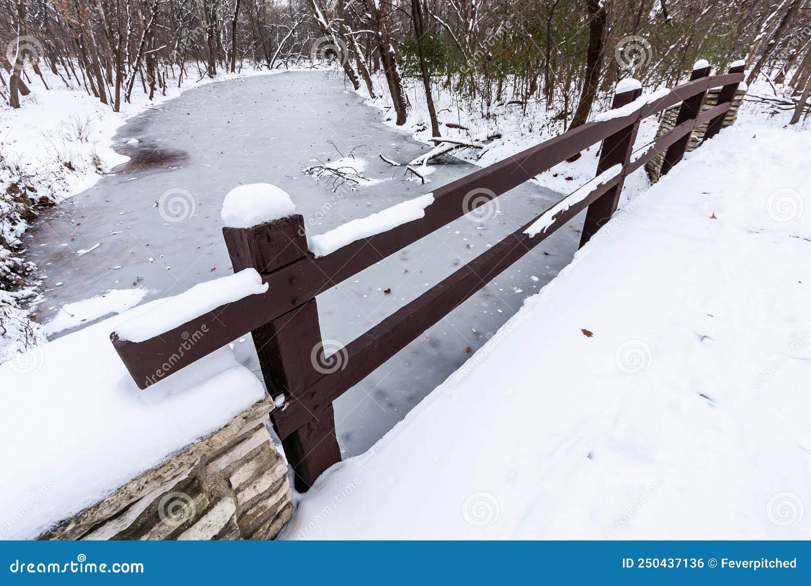 Rustic Bridge Over Frozen River in Winter Stock Photo - Image of snow ...