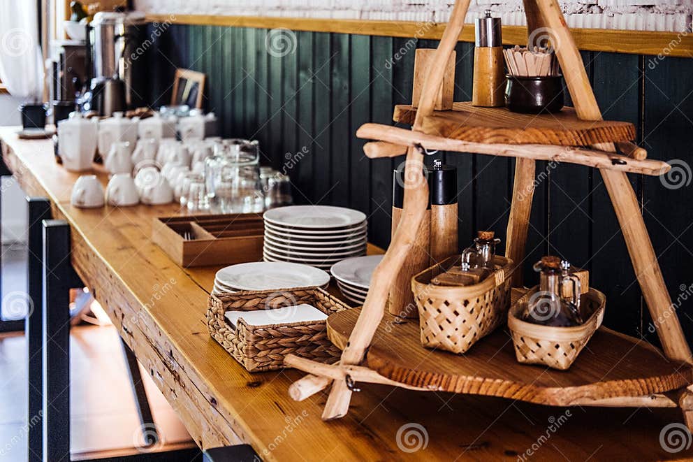 Rustic Buffet Table Setup with Plates, Cups, Glasses, and Wooden ...
