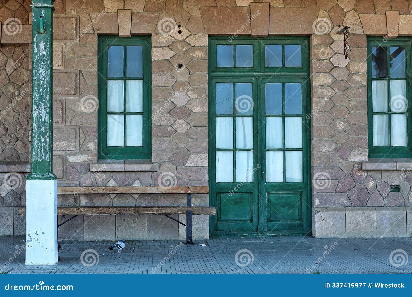 Rustic Building Facade with Green Windows and Doors Stock Image - Image ...