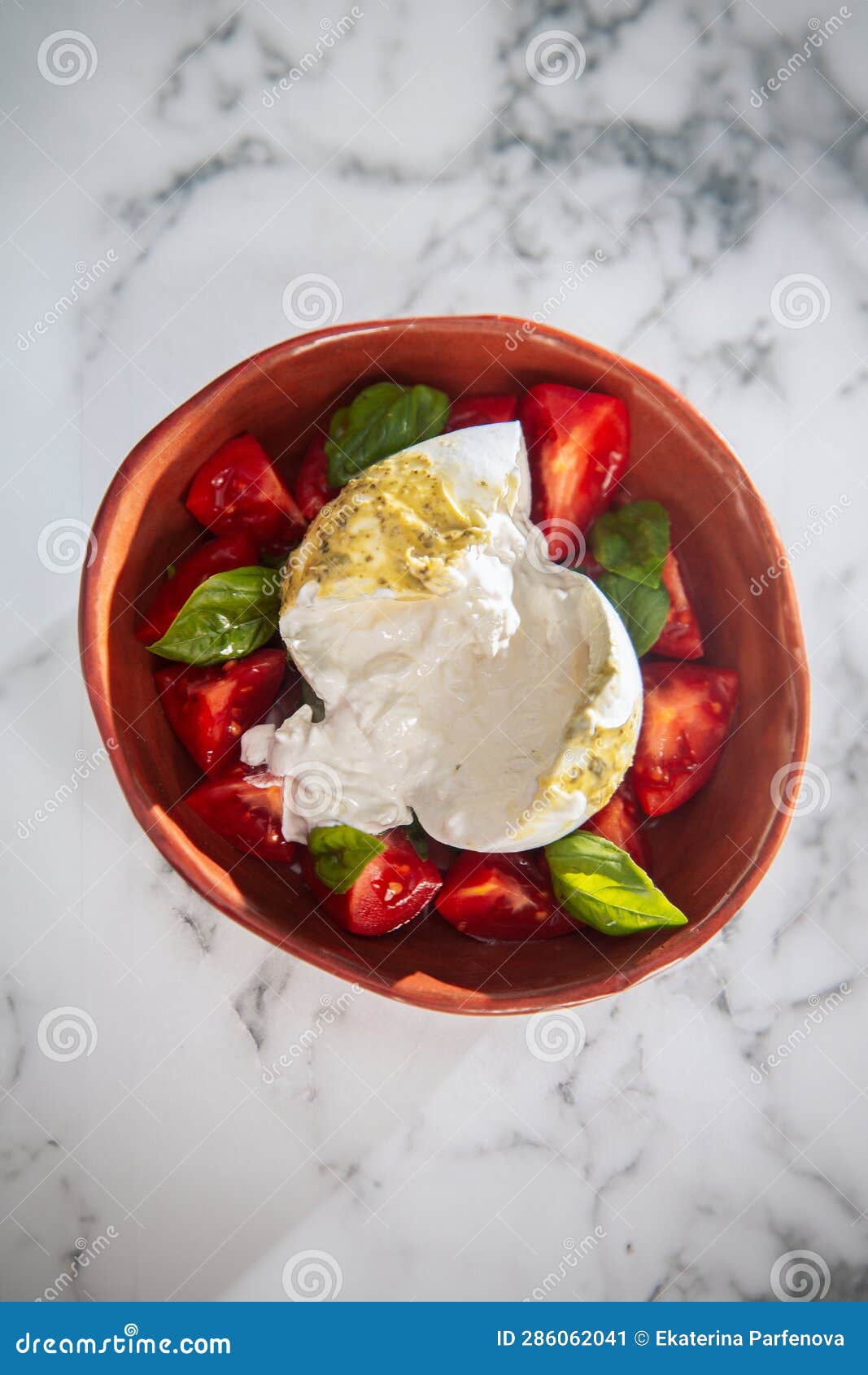 Buratta with Tomatoes and Basil in a Clay Bowl. Stock Image - Image of ...