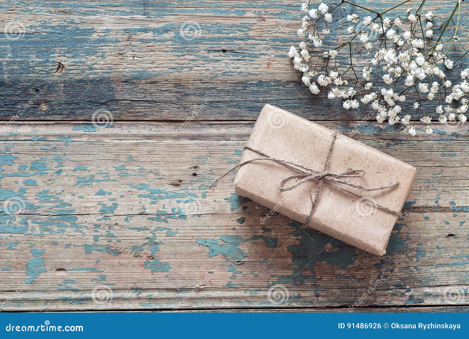 Rustic Gift Box with Floweron the Old Grunge Painted Boards. Place for ...