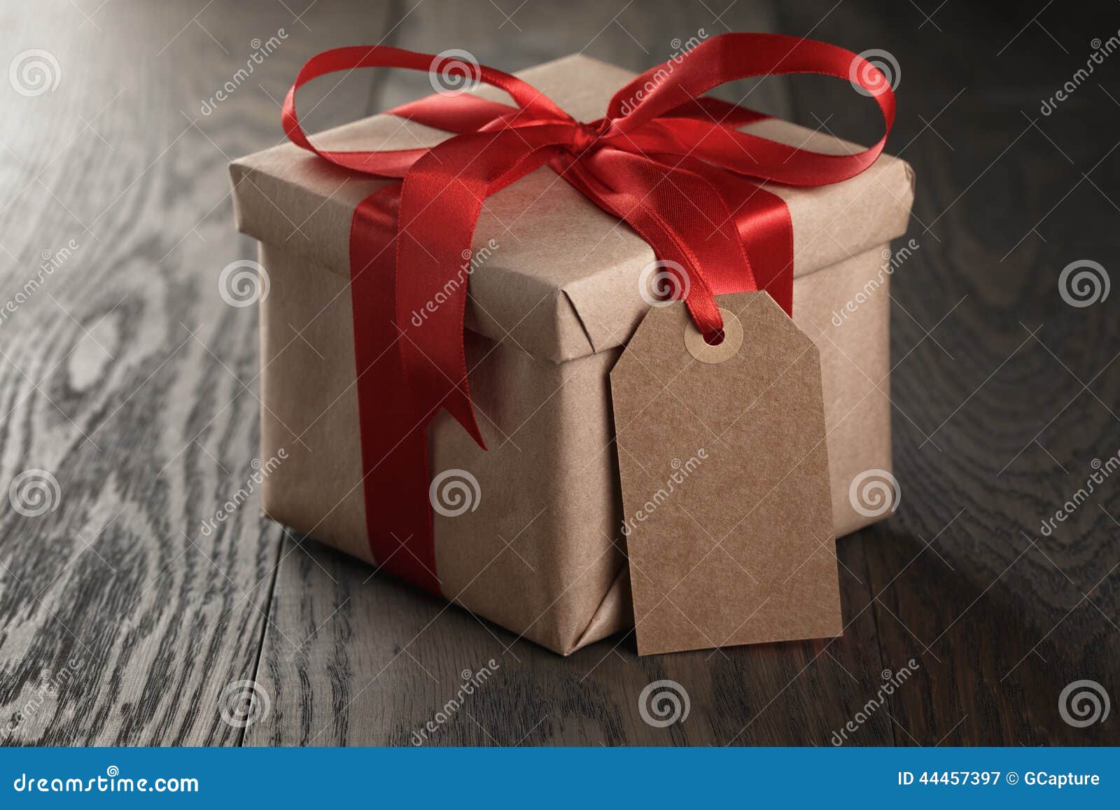 Rustic Gift Box with Red Ribbon Bow and Empty Tag Stock Image - Image ...