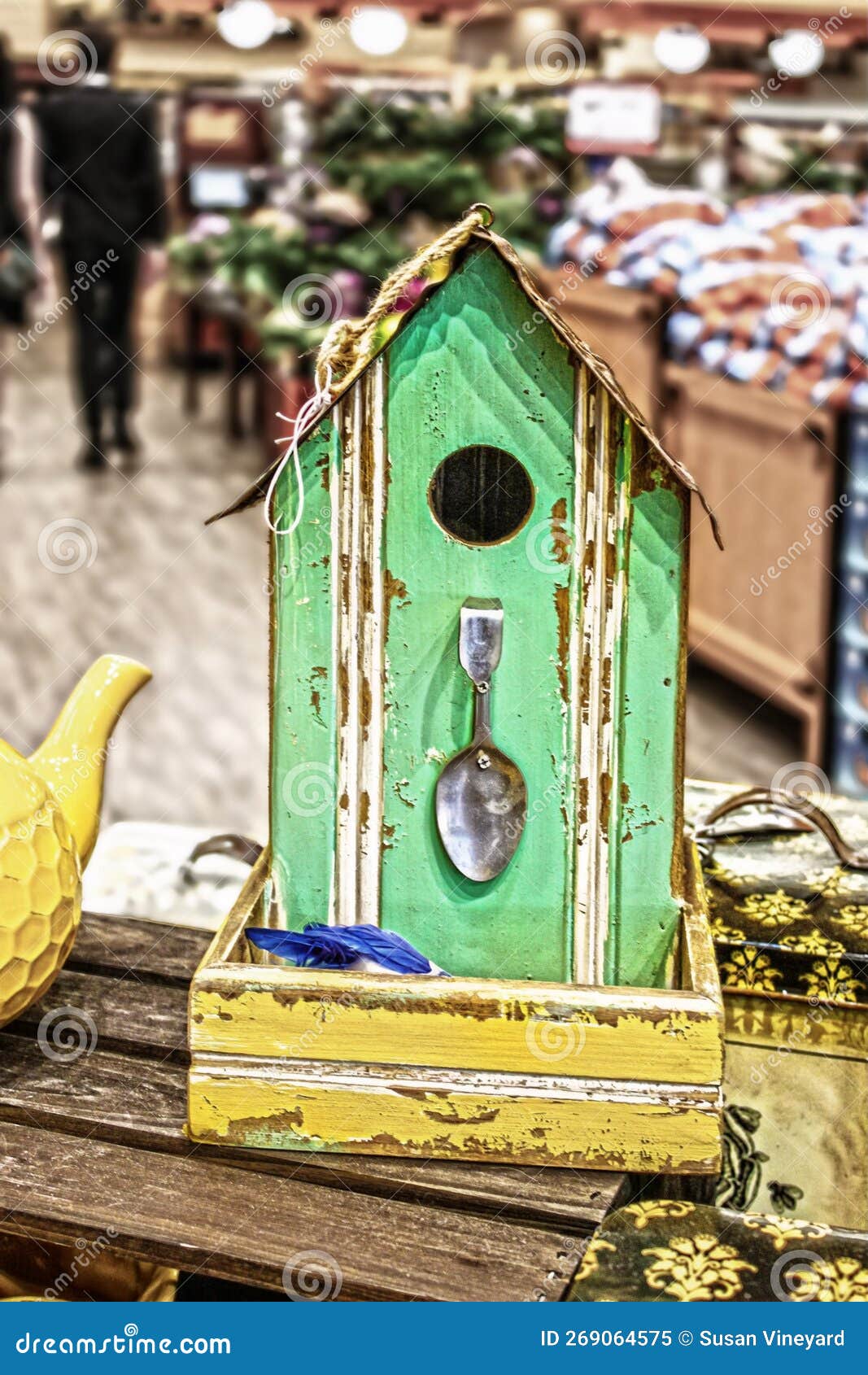 Rustic Green Birdhouse with Silver Spoon in Store Display with Blurred ...