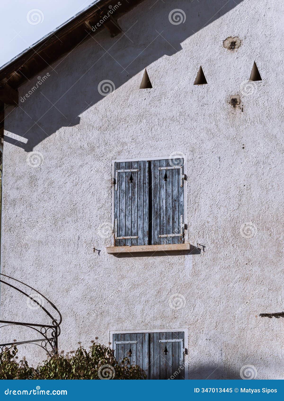 Rustic House with Blue Shutters and Textured Wall Stock Image - Image ...