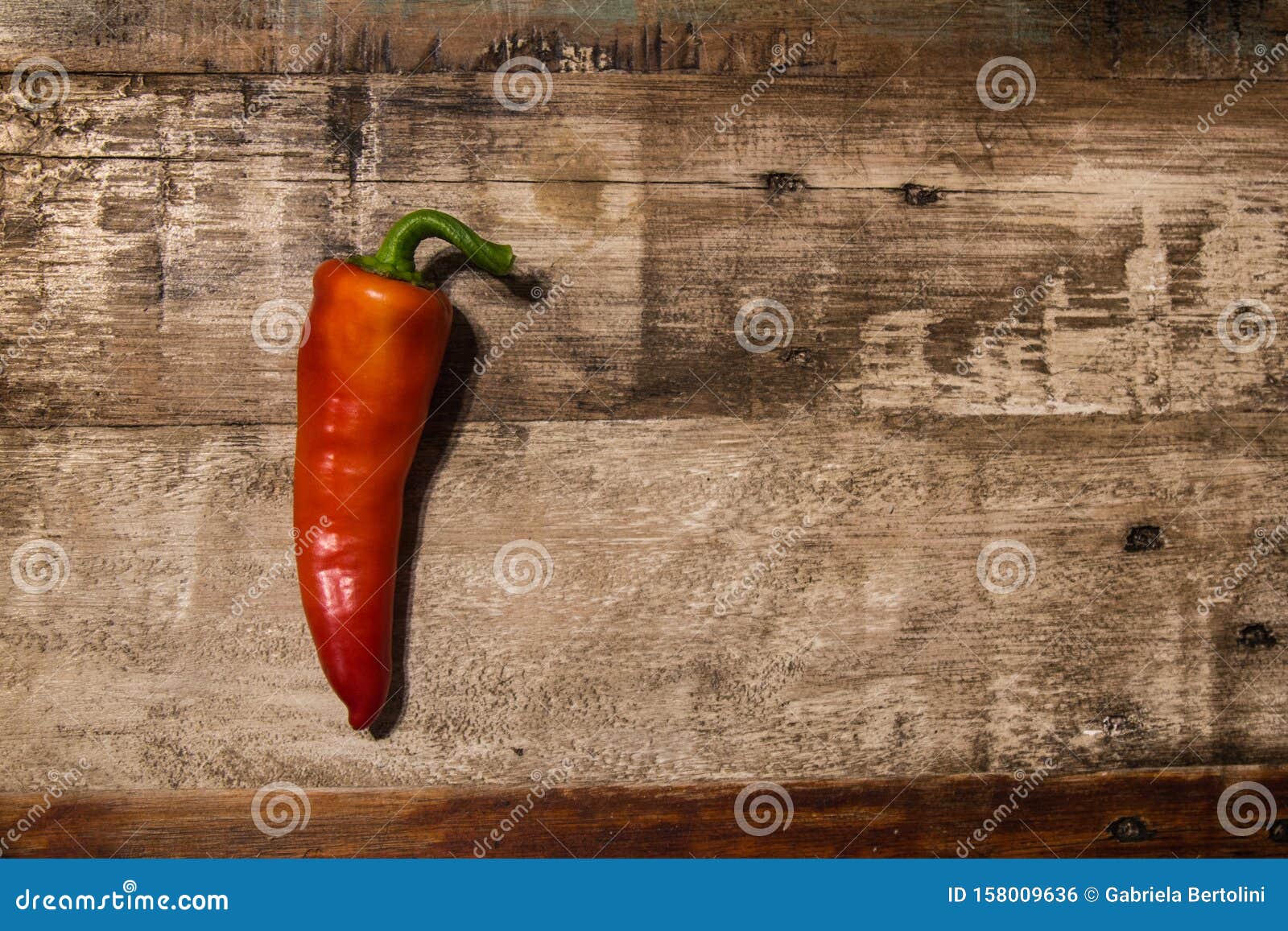 A Red Pepper Isolated on Rustic Wooden Background Stock Photo - Image ...