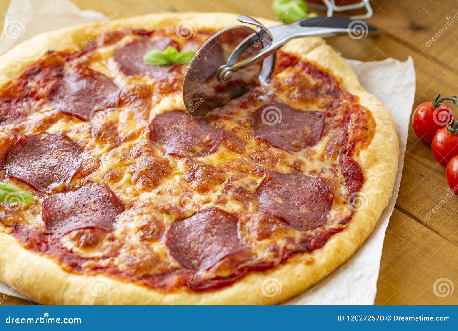 Rustic Pizza with Salami, Mozzarella, Olives and Basil. Stock Photo ...