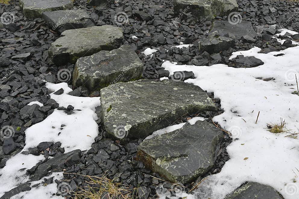 A Rustic Stone Path Winds through a Rugged Landscape, Partially Covered ...
