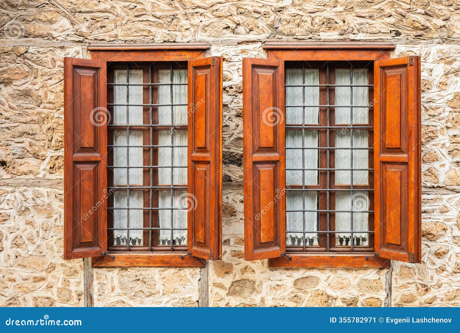 Rustic Stone Wall with Wooden Shuttered Windows Stock Image - Image of ...