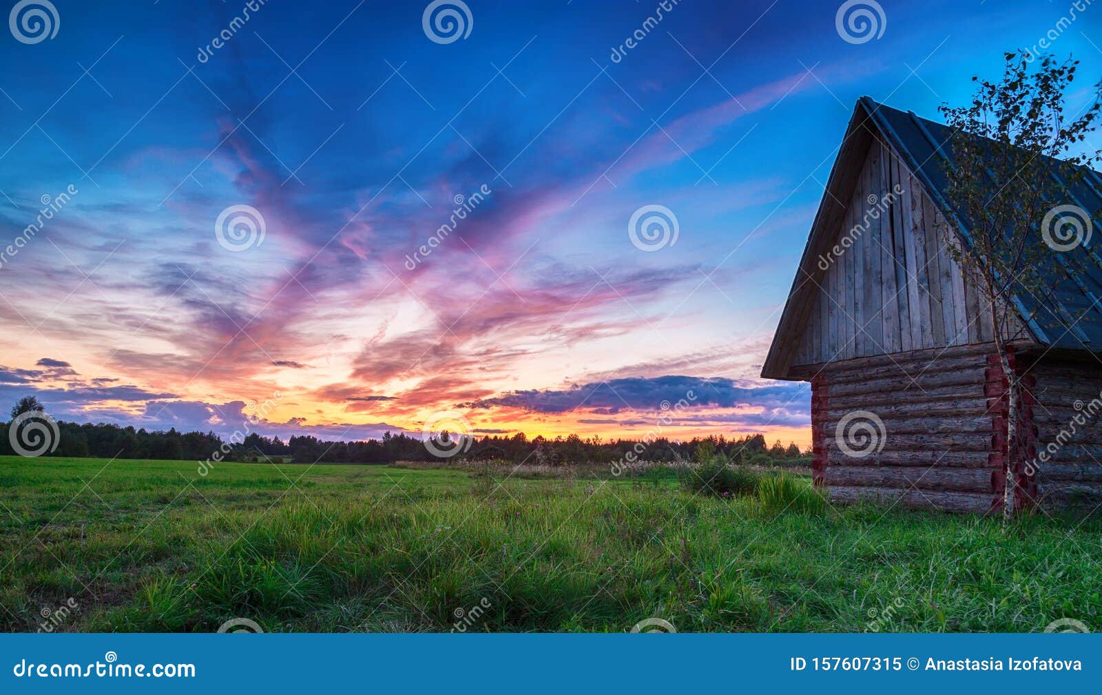 Rustic Sunset. Skyline with Log House in the Foreground Stock Image ...