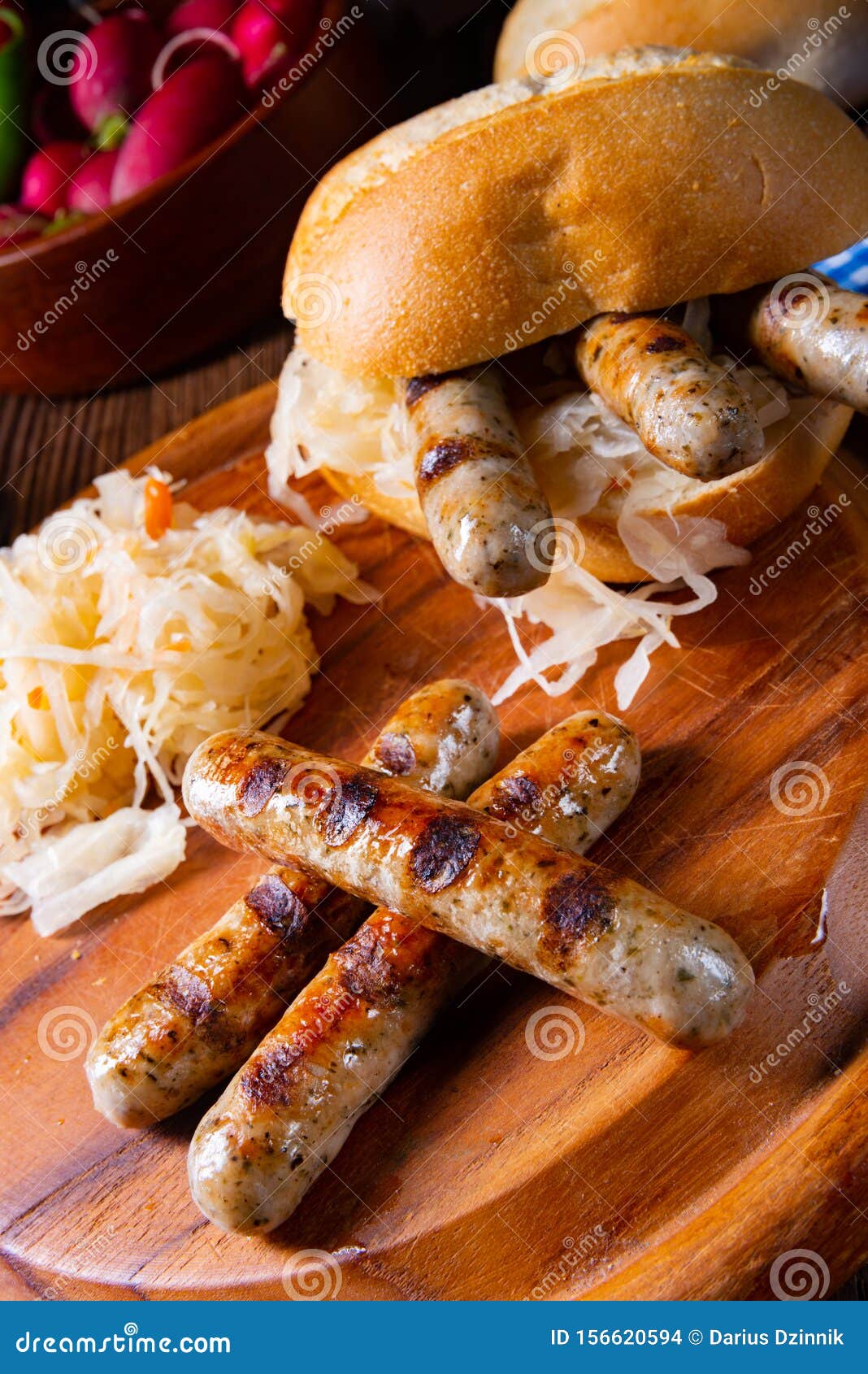 Rustic Thuringian Bratwurst with Sauerkraut and Roll Stock Photo ...