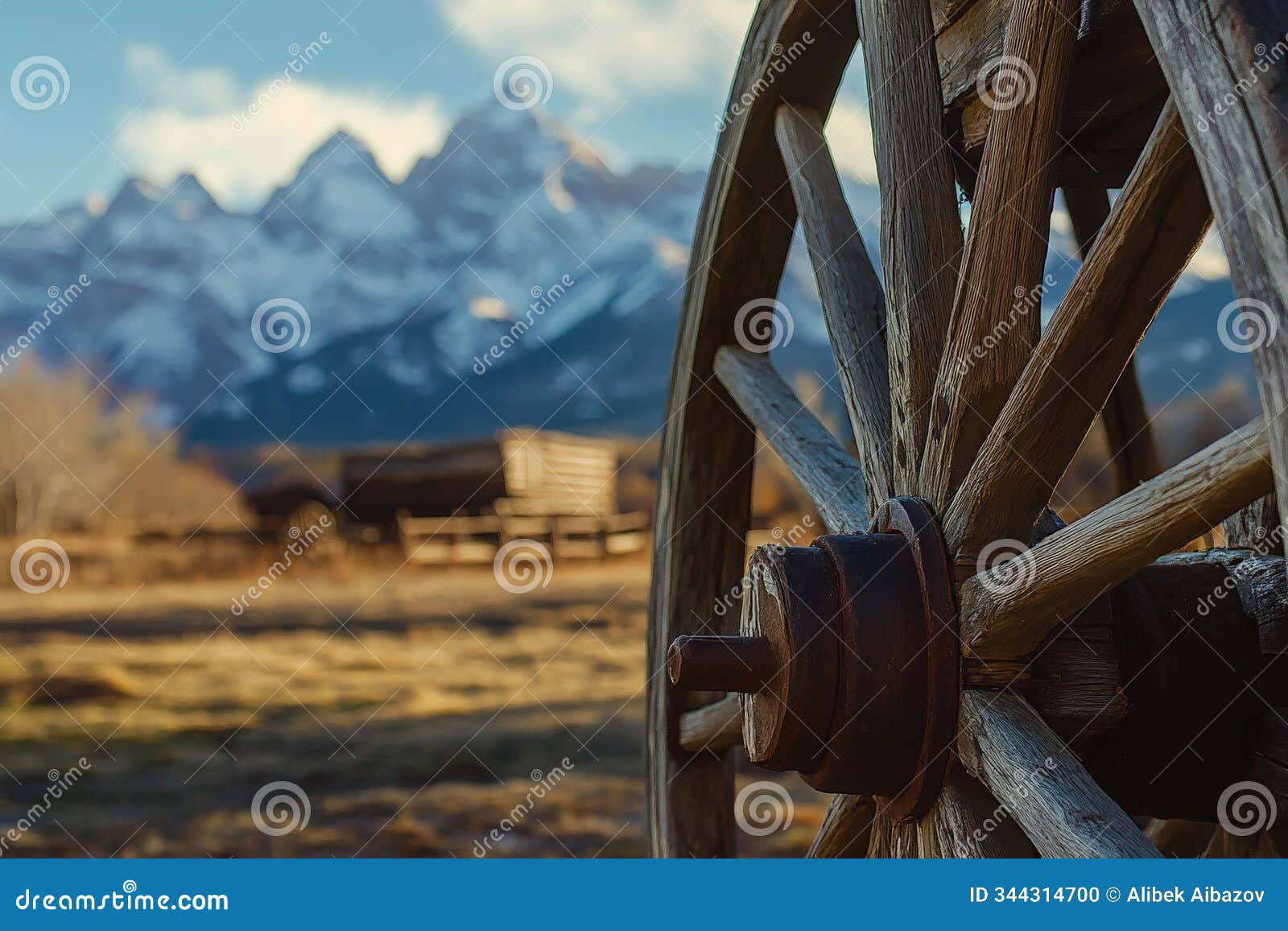 Rustic Wagon Wheel with Mountain Backdrop in Serene Landscape Stock ...