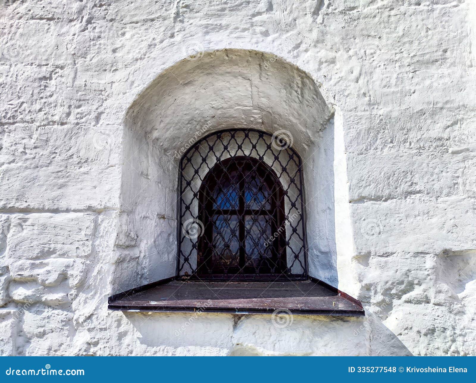 A Rustic Window Featuring Intricate Lattice Work Set Against a Textured ...