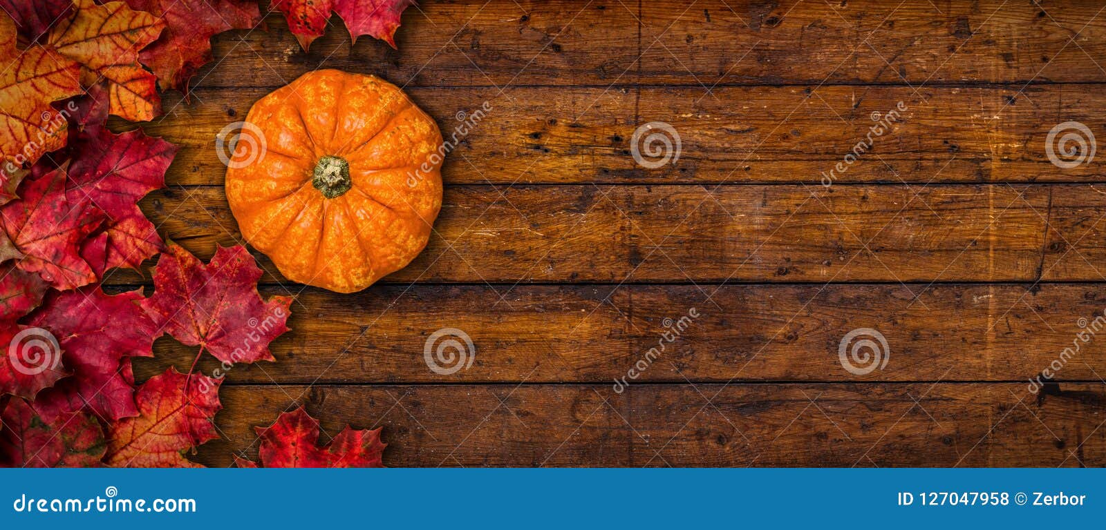 A Rustic Wooden Background with Autumn Foliage and a Pumpkin Stock ...