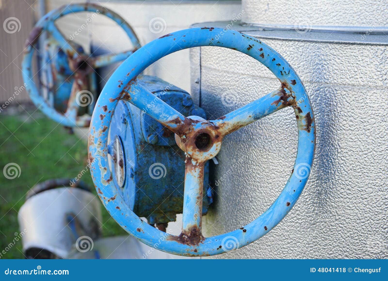 A rusty blue valve handle stock photo. Image of machinery - 48041418