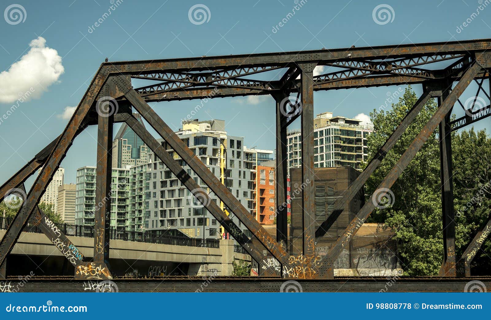 Rusty Bridge with Buildings in the Background Stock Photo - Image of ...