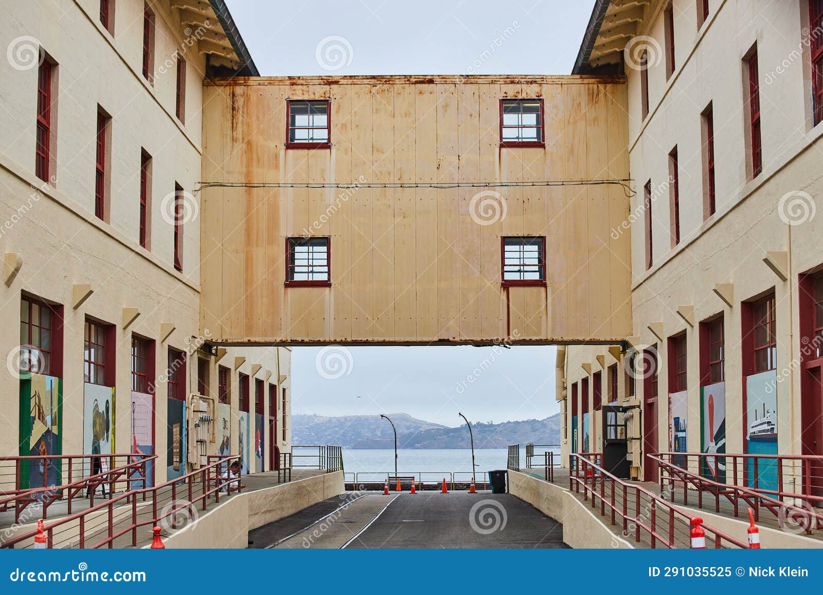 Rusty Bridge between Two Warehouse Buildings with Road Underneath and ...