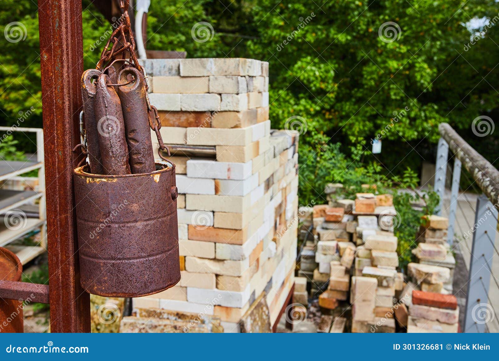 Rusty Bucket and Bricks at Construction Site with Greenery Background ...