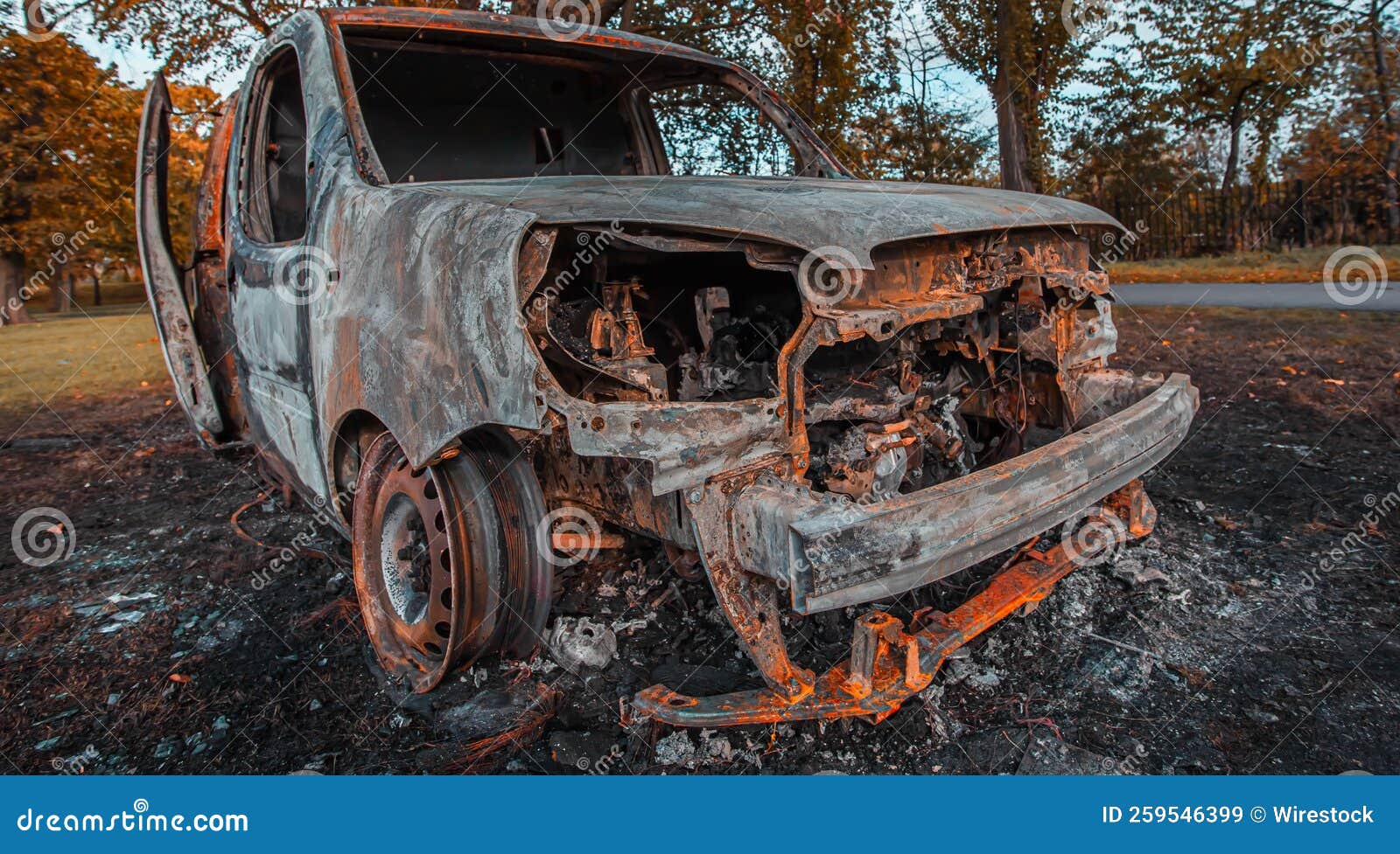 Rusty Burned Abandoned Car in a Park with Autumn Trees Stock Image ...