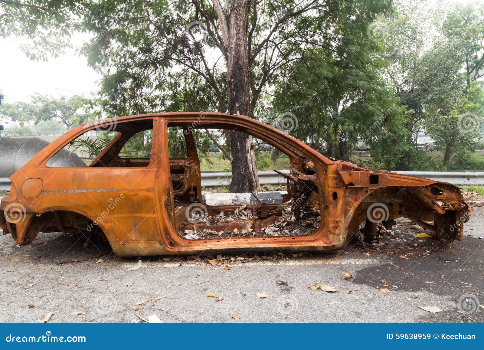 Rusty Chassis Of A Burnt Car Abandoned By The Side Of The Street ...