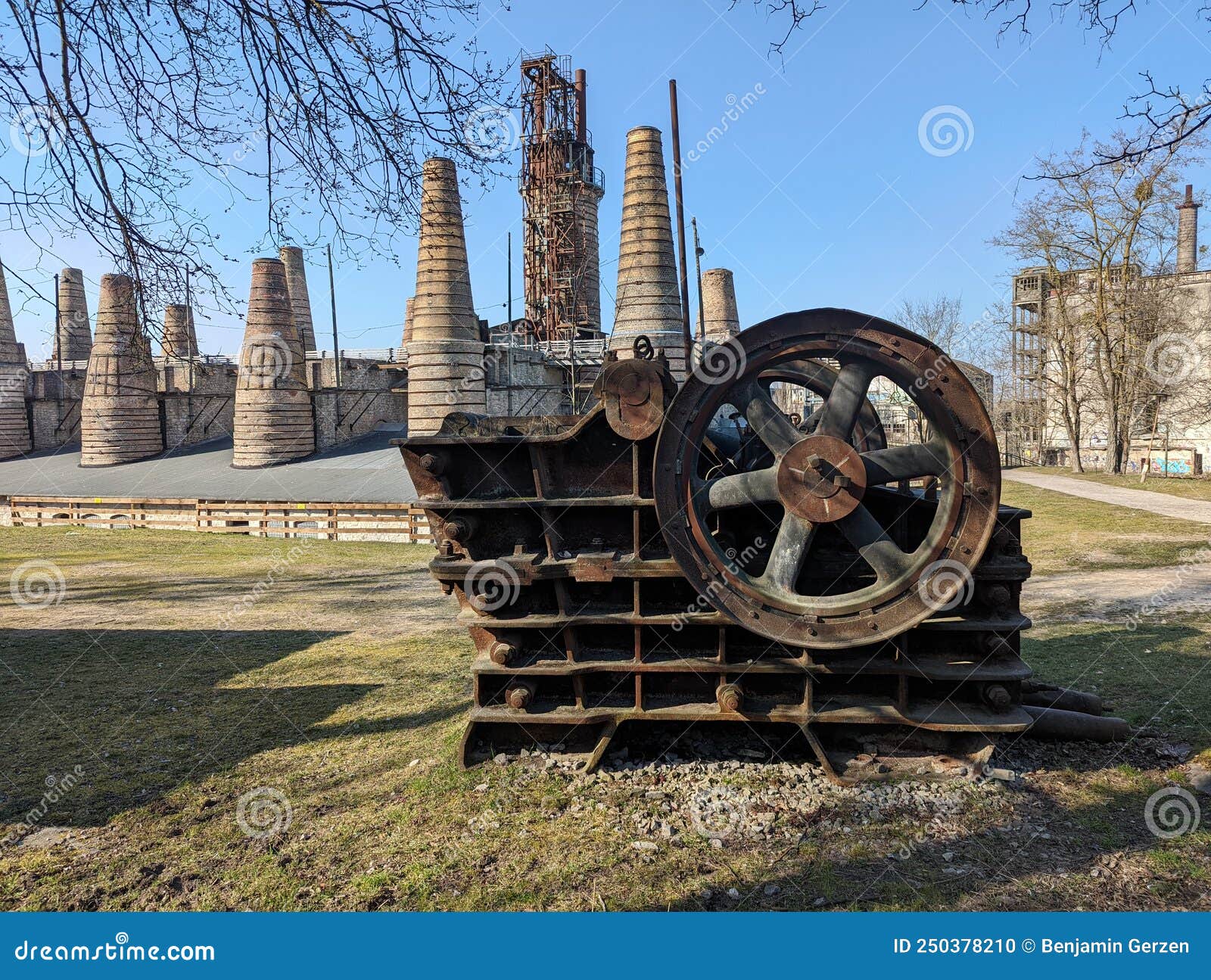 Rusty Construction with Wheel and Abandoned Factory in Background ...