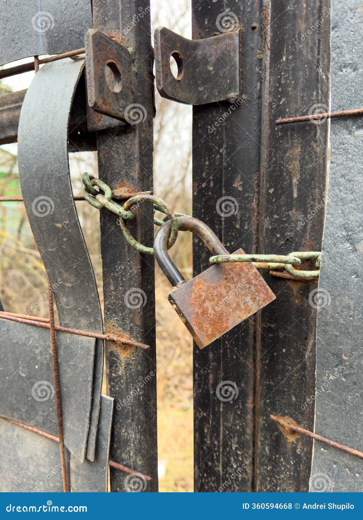A Rusty Gate Latch Is Shown In Front Of A White House Royalty-Free ...