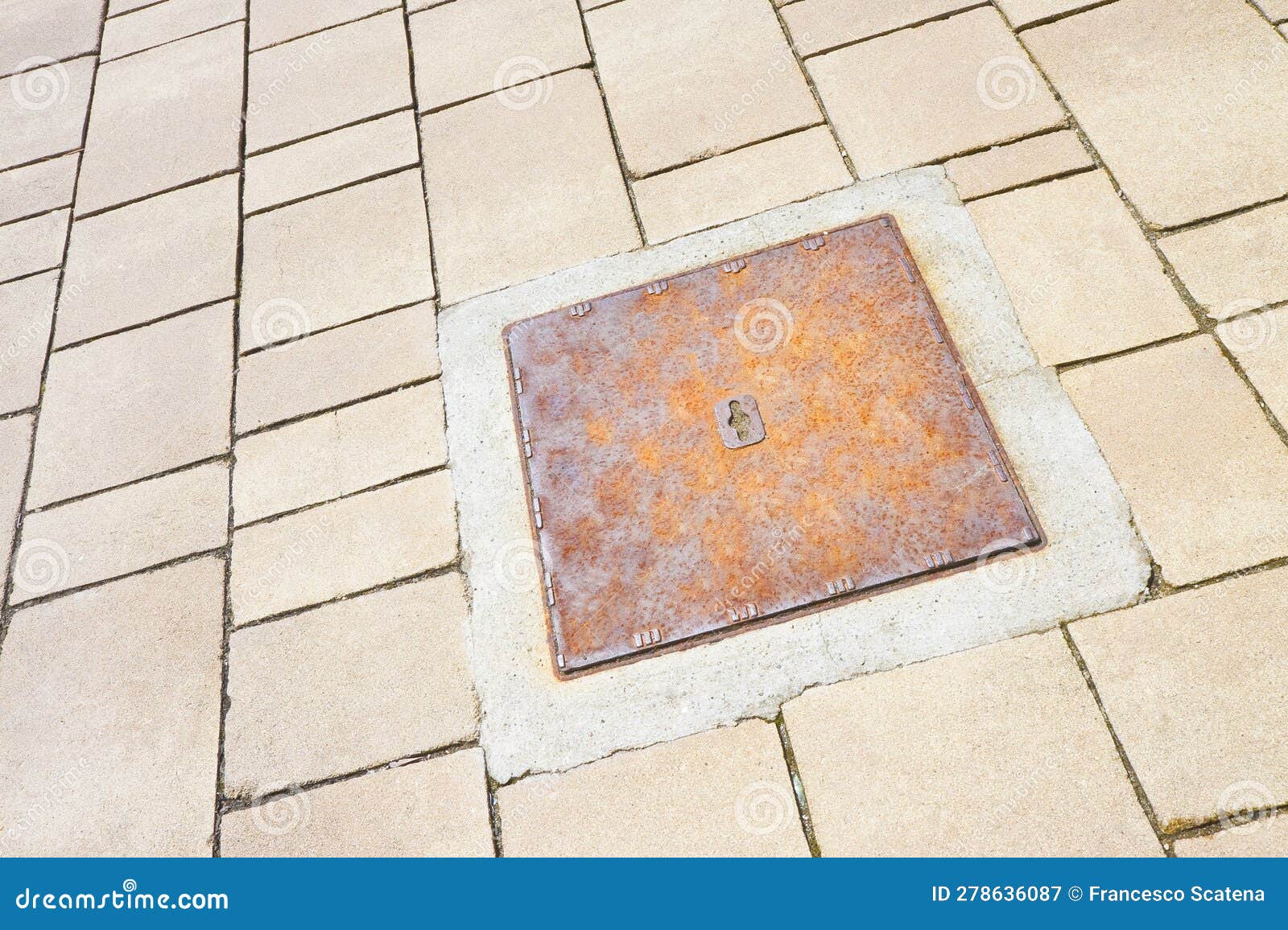 Rusty Iron Cast Manholes in a Modern Stone Paving Stock Image - Image ...