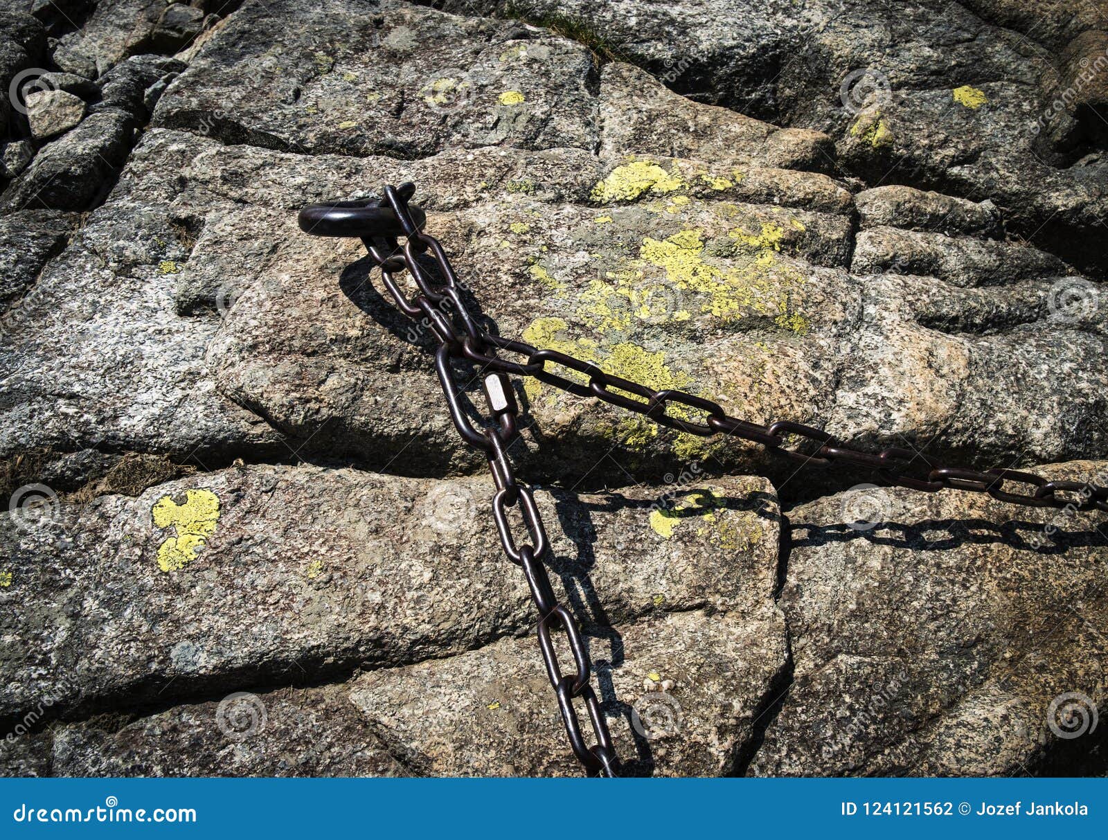 A Rusty Iron Chain on a Granite Rock Stock Photo - Image of heavy ...