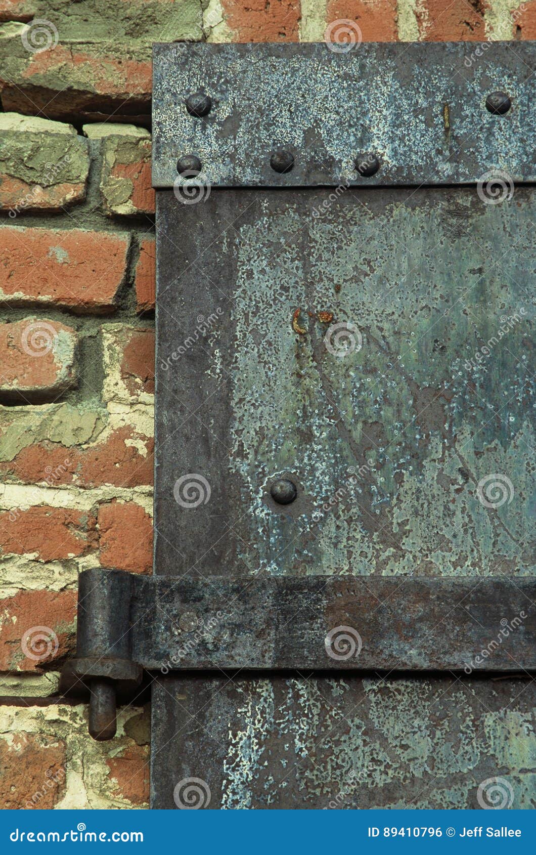 Rusty iron door on brick stock photo. Image of pivot - 89410796