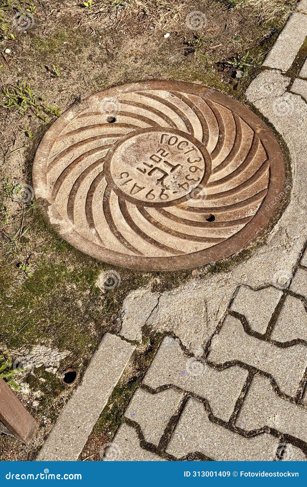 A Rusty Iron Hatch with a Pattern is Mounted in the Asphalt Pavement of ...