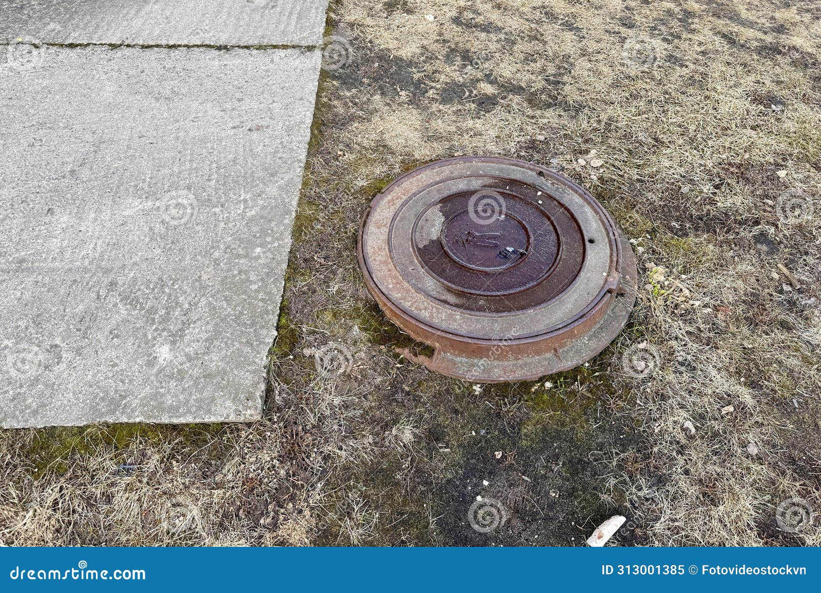 A Rusty Iron Hatch with a Pattern is Located Next To a Dry Grass ...
