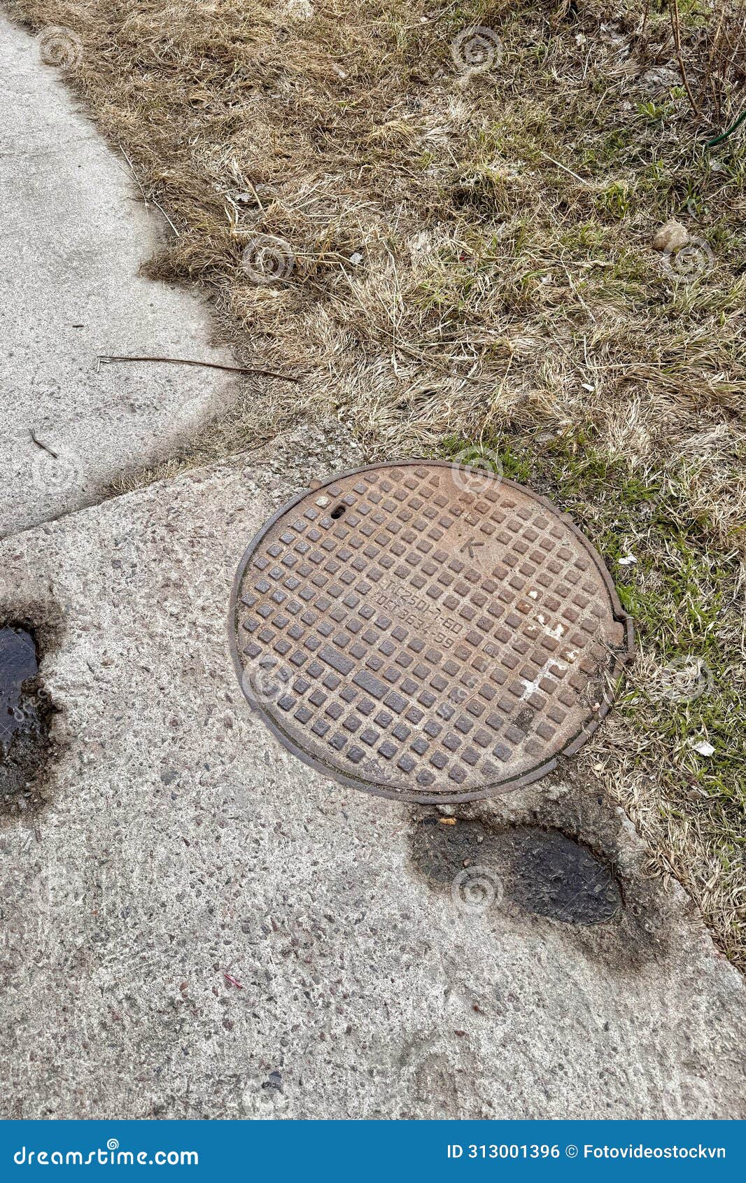 A Rusty Iron Hatch with a Pattern is Mounted in the Asphalt Pavement of ...