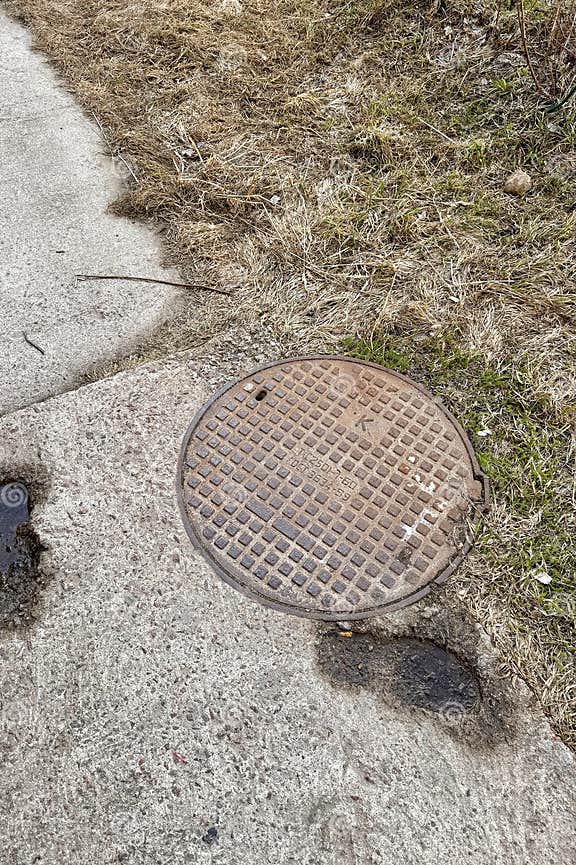 A Rusty Iron Hatch with a Pattern is Mounted in the Asphalt Pavement of ...
