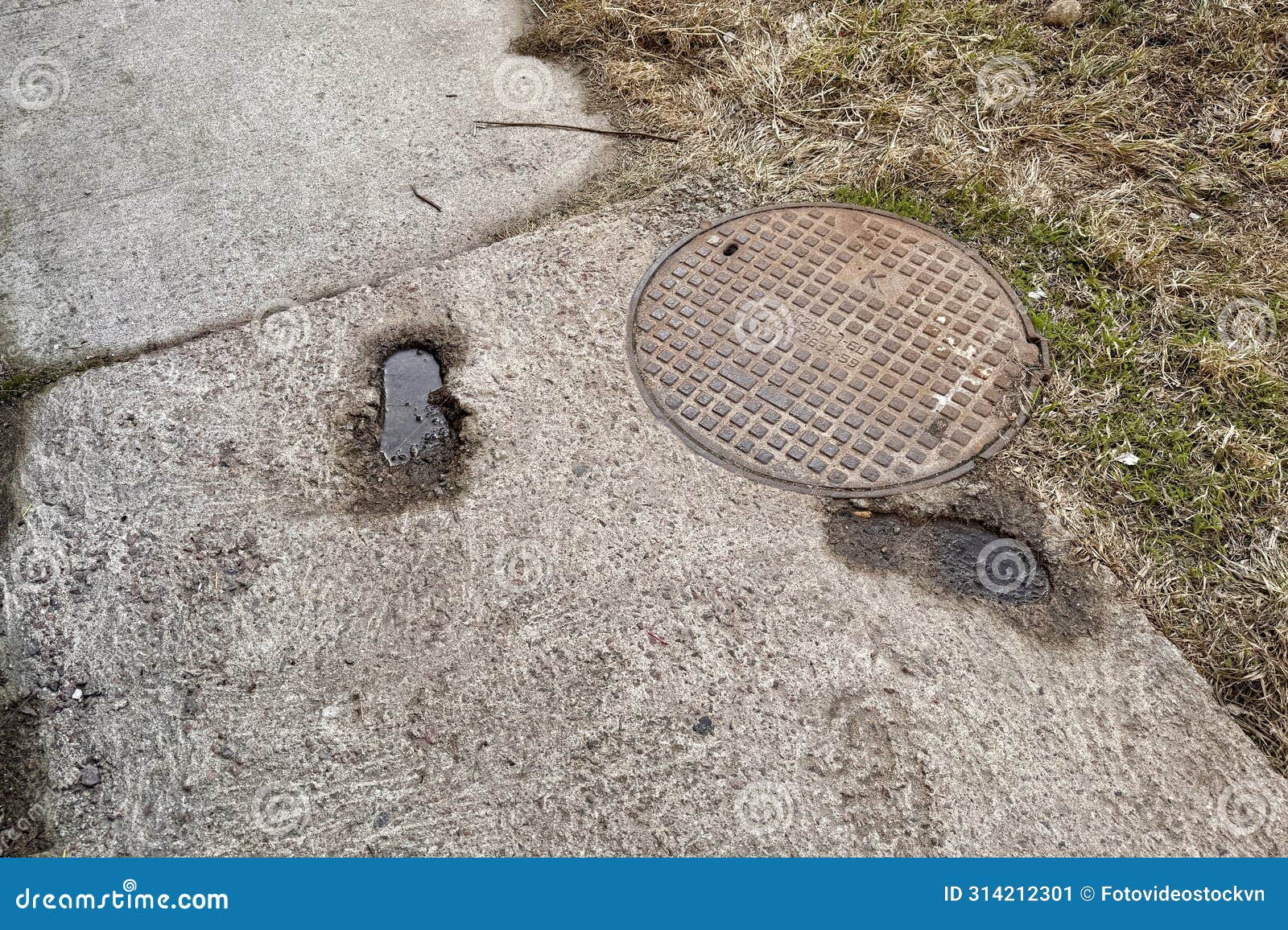 A Rusty Iron Hatch with a Pattern is Mounted in the Asphalt Pavement of ...