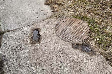 A Rusty Iron Hatch with a Pattern is Mounted in the Asphalt Pavement of ...