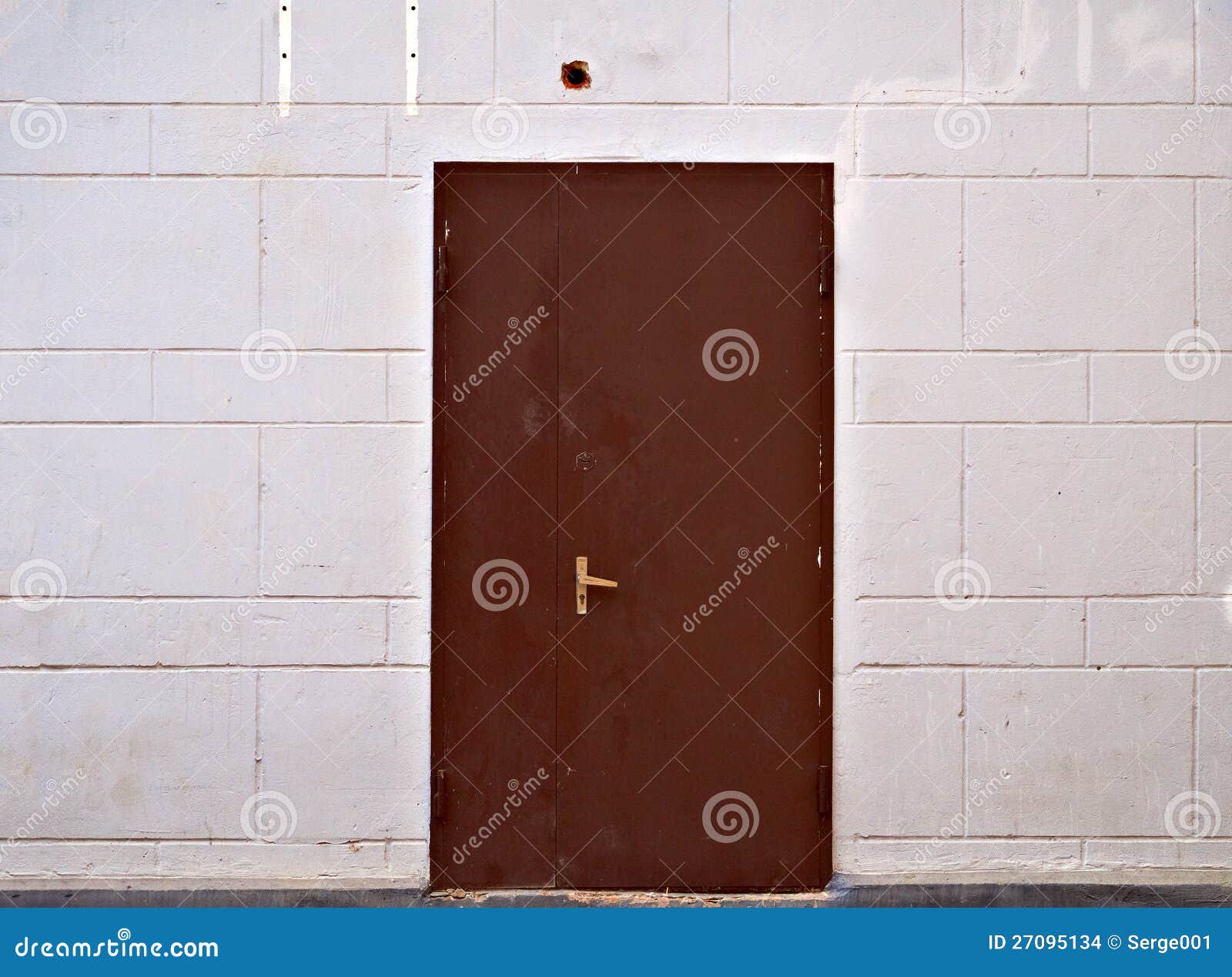 Rusty Metal Door in Beige Block Wall Stock Photo - Image of brown ...
