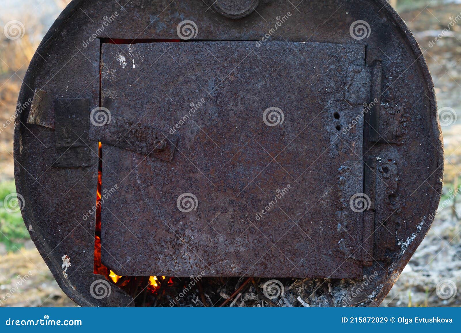 A Rusty Metal Stove with a Fire Behind a Closed Door Stock Image ...