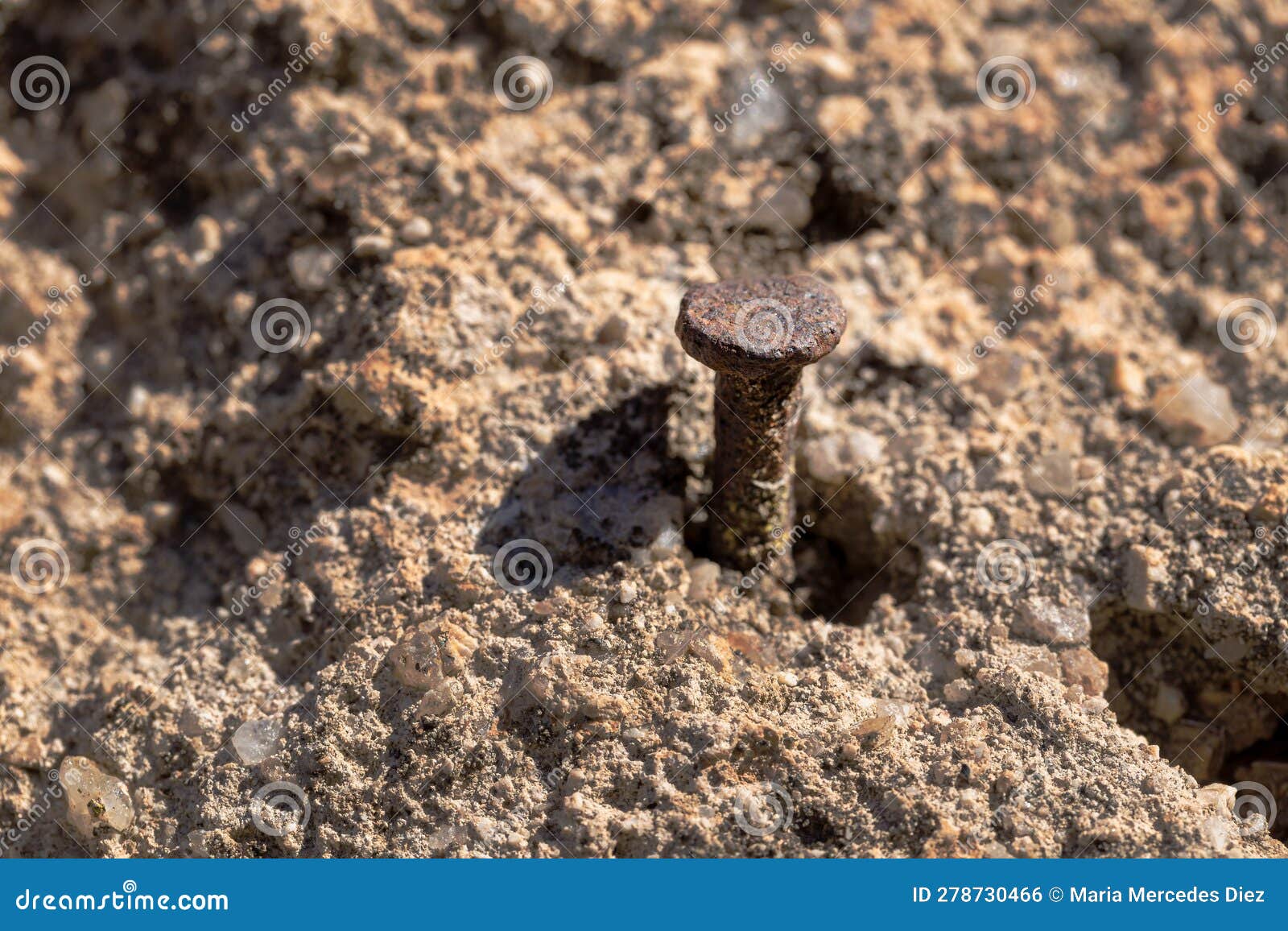 A Rusty Nail or Spike Driven into a Rock. Horizontal Stock Photo ...