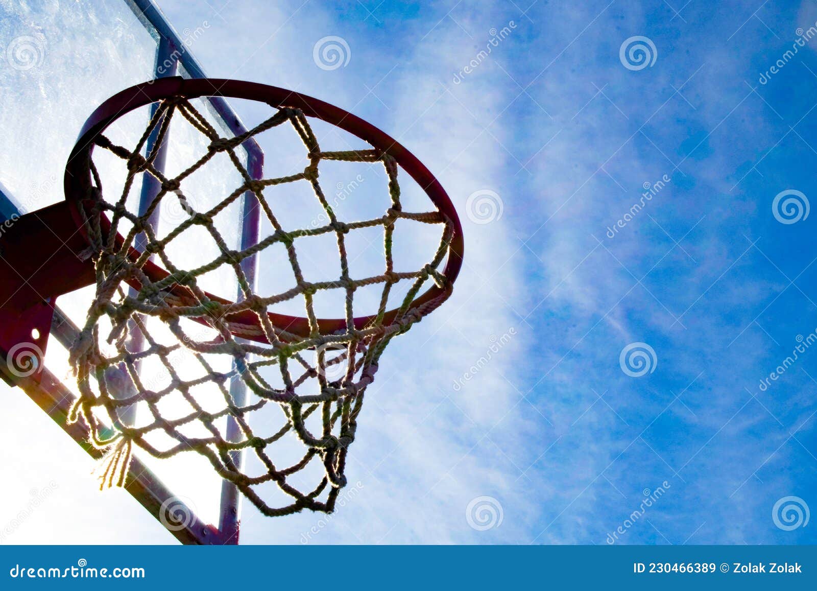 A Rusty Old Basketball Hoop Against a Blue Sky in the Evening Stock ...