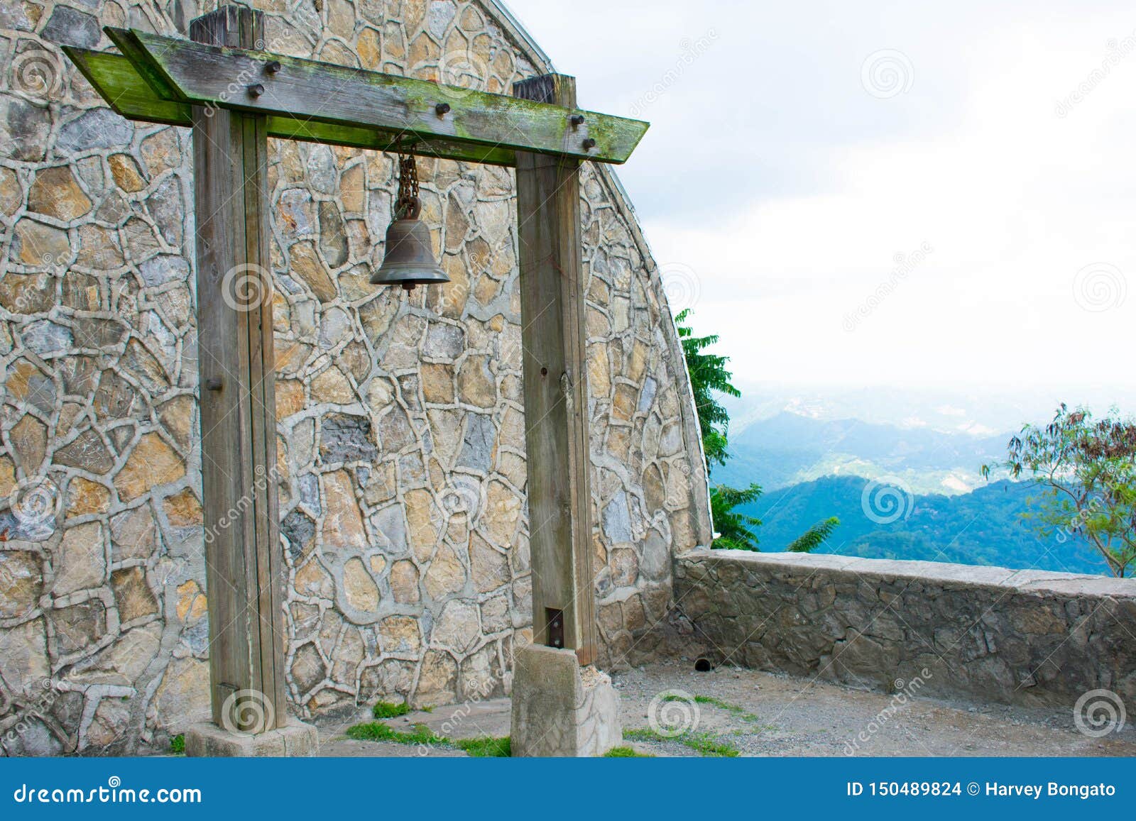 Rusty Old Bell Hanged in Mossy Wood Pillar with Stone Pattern Arc Wall ...