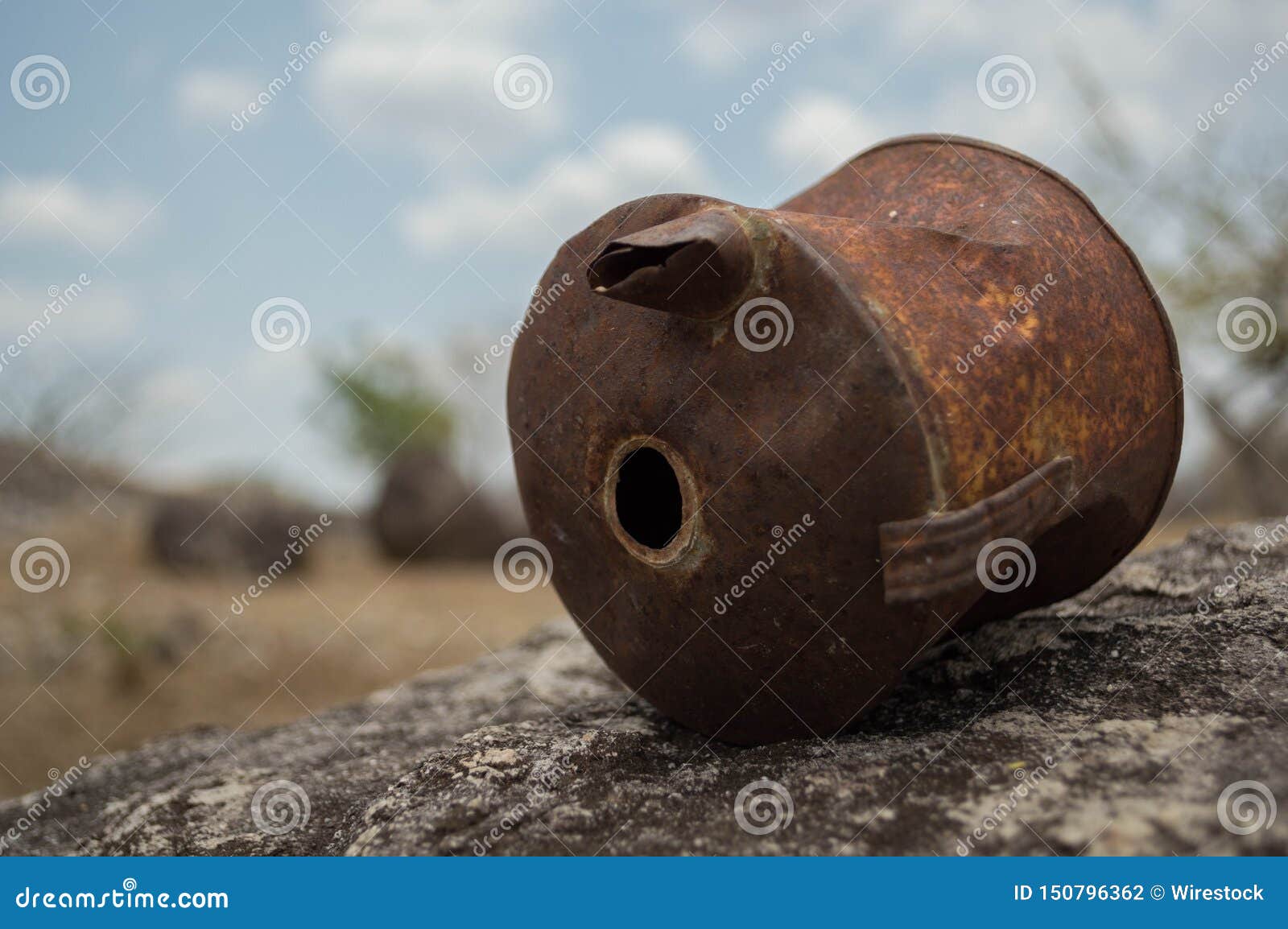 Rusty Old Can on a Rock in a Desert Stock Photo - Image of ground ...