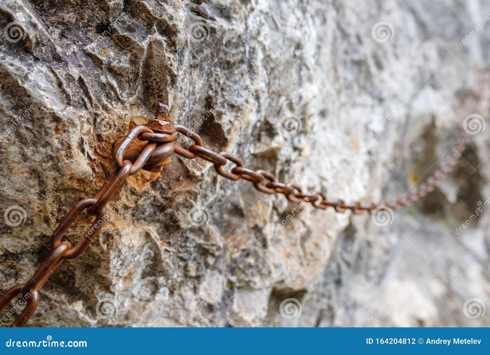 A Rusty Old Metal Chain is Embedded in a Rock in the Park Stock Photo ...