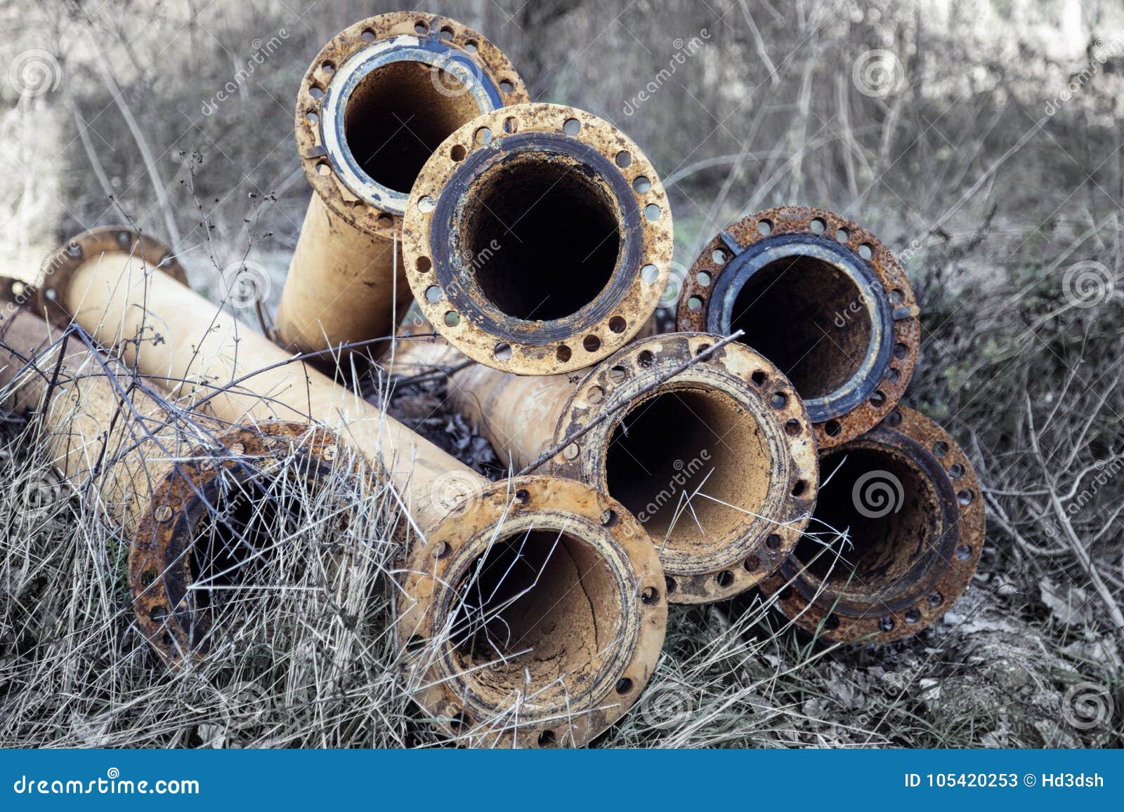 Rusty Old Water Sewer Pipes in the Tall Dry Grass Stock Image - Image ...