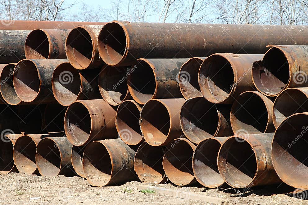 The Rusty Pipes of Large Diameter Stored on the Ground. Stock Photo ...