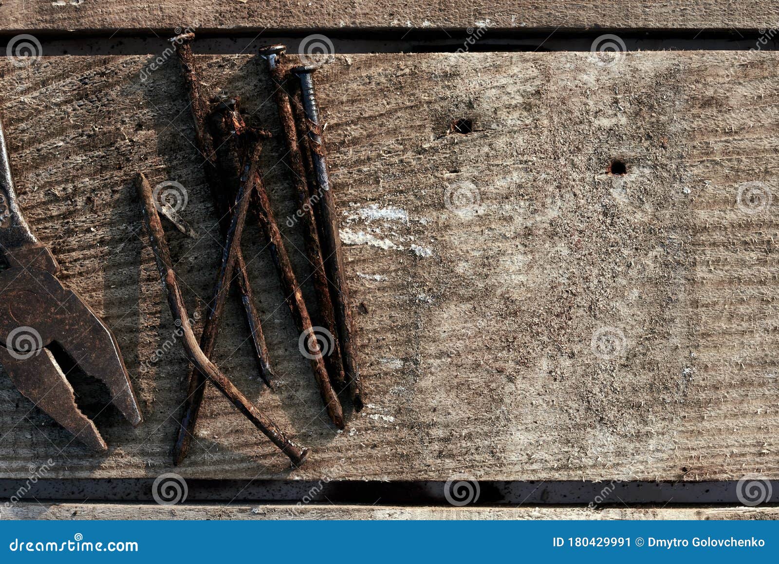 Rusty Pliers And Bent Old Nails Lie On A Tree Desktop. Rust. Cracked ...